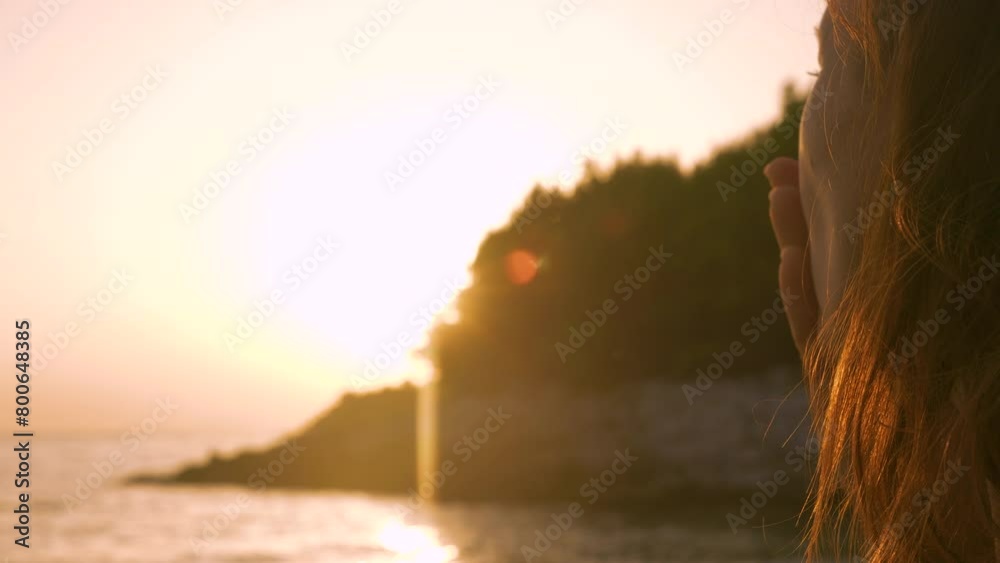 LENS FLARE, PORTRAIT, SILHOUETTE Lady sends a kiss towards golden sun ...