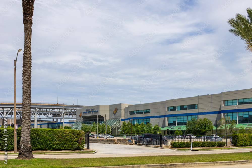 Ernest N. Morial Convention Center with lush green trees and grass ...