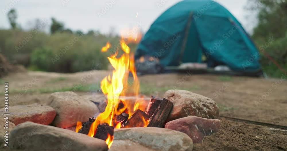 Fire, nature and camping wood with tent with heat and flames in the ...