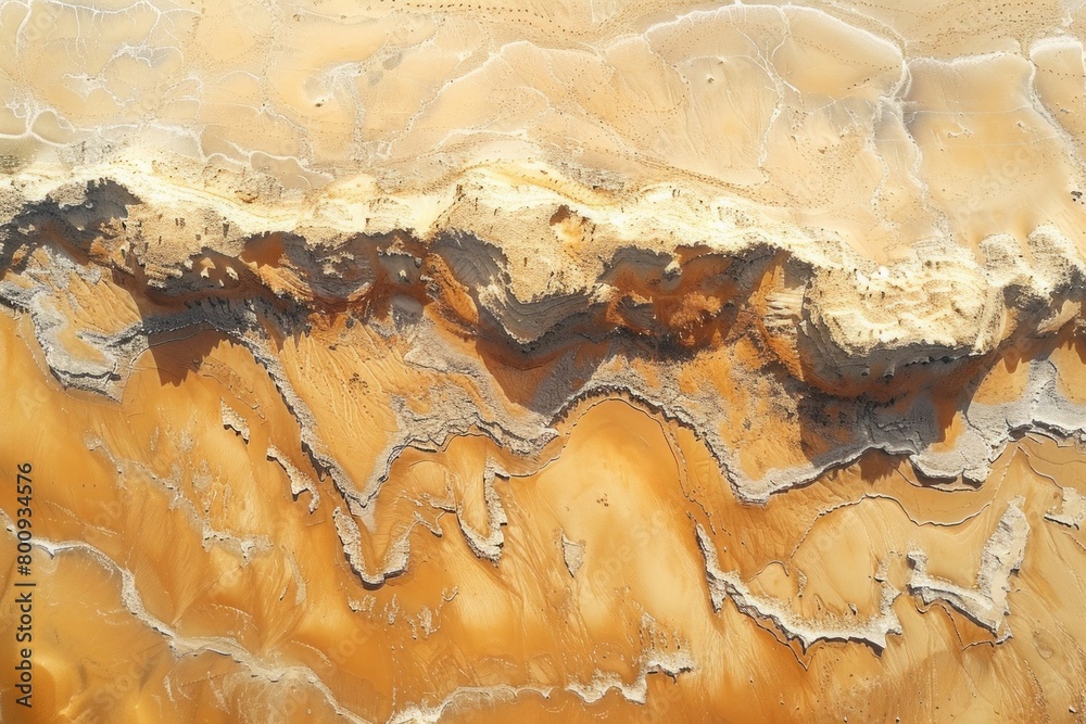 From the bird's-eye view, observe the sandy expanse taking shape, its ...