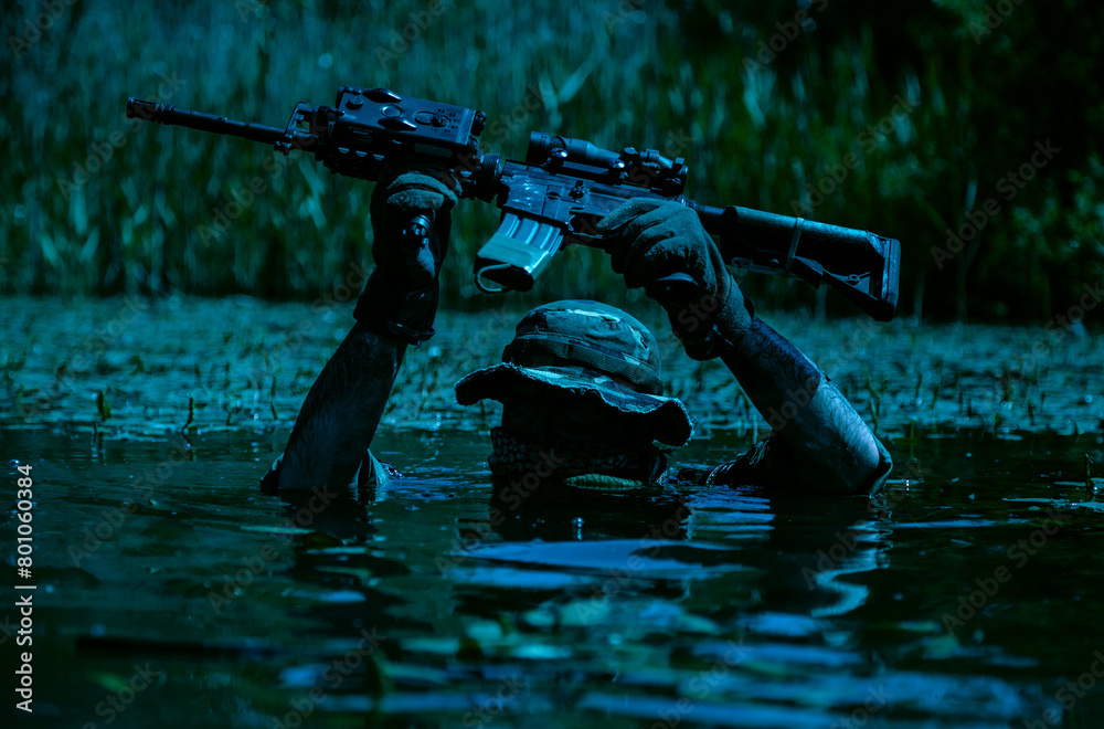 A soldier moves in the heart of a marsh, submerged in swampy waters ...