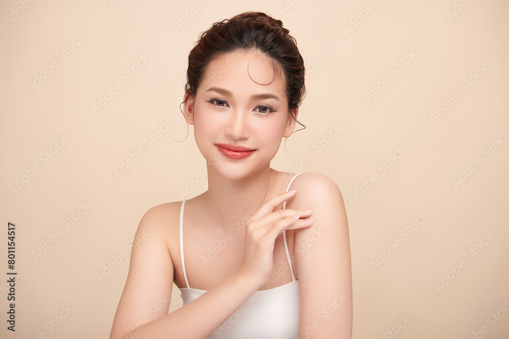 Beautiful young asian woman with clean fresh skin on beige background ...
