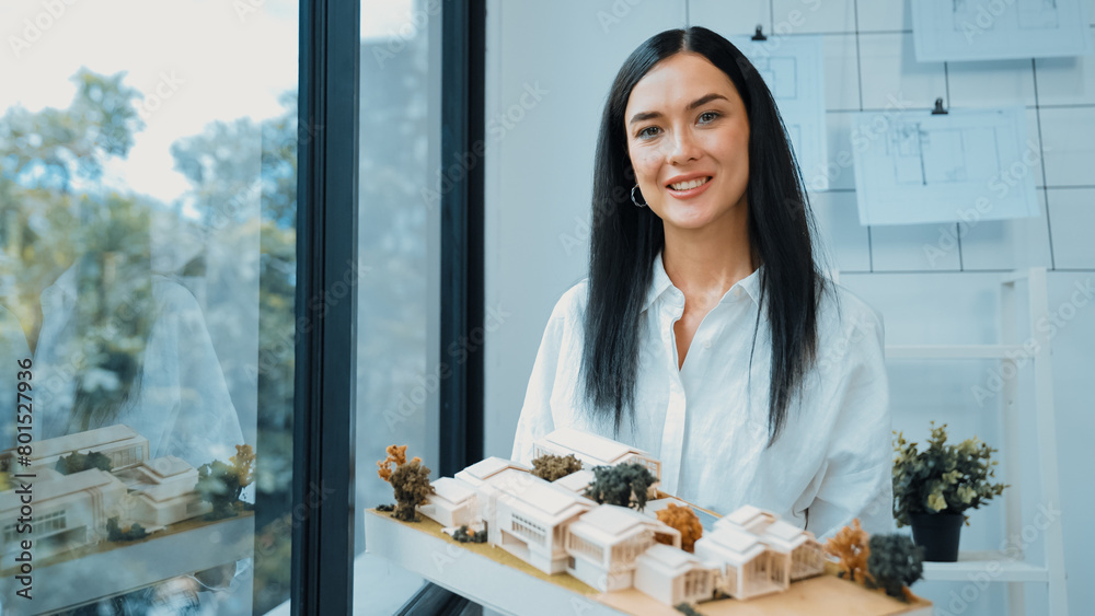 Close up of skilled young beautiful caucasian architect lift house ...