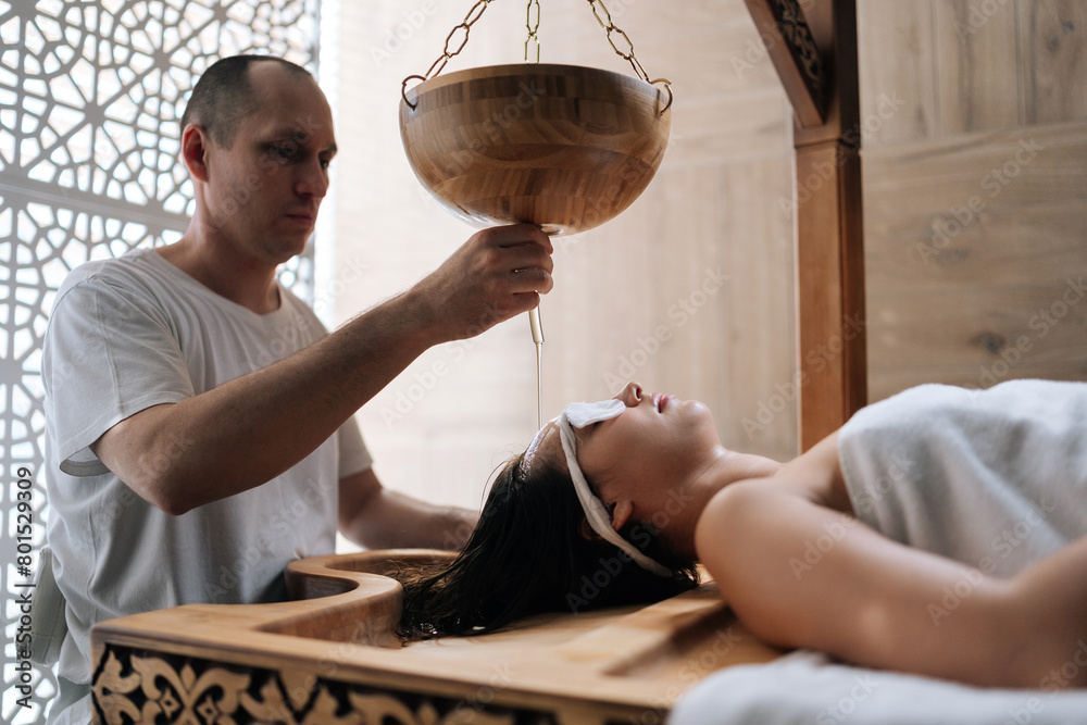 Relaxed young woman peaceful resting while stream of oil covering her ...