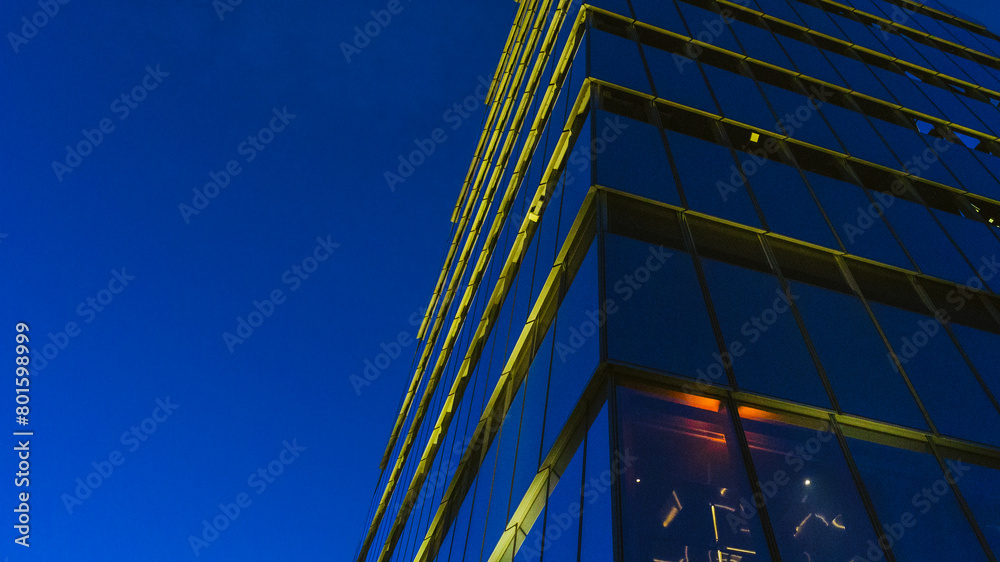 Glass wall of modern high rise office tower under the dusk dark ...