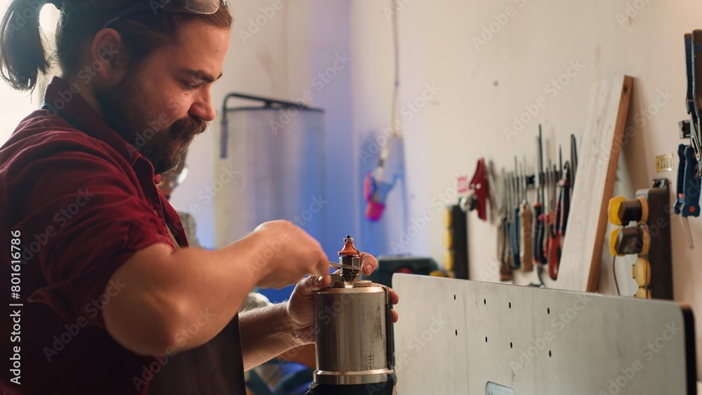 Mechanic in carpentry shop changing rotor part on spindle moulder ...