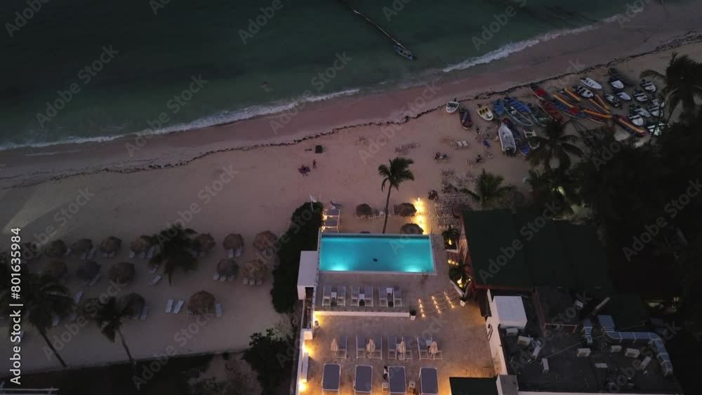 Overhead perspective of beachfront building featuring pool during ...
