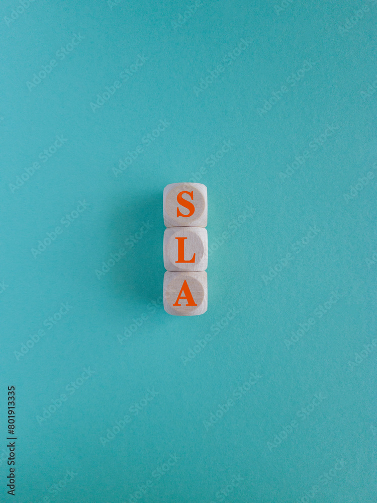 SLA service level agreement symbol. Concept words SLA on wooden cubes ...