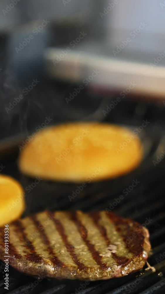 Minced ground meat cooking on grill .Beef meat patty grilling with two ...
