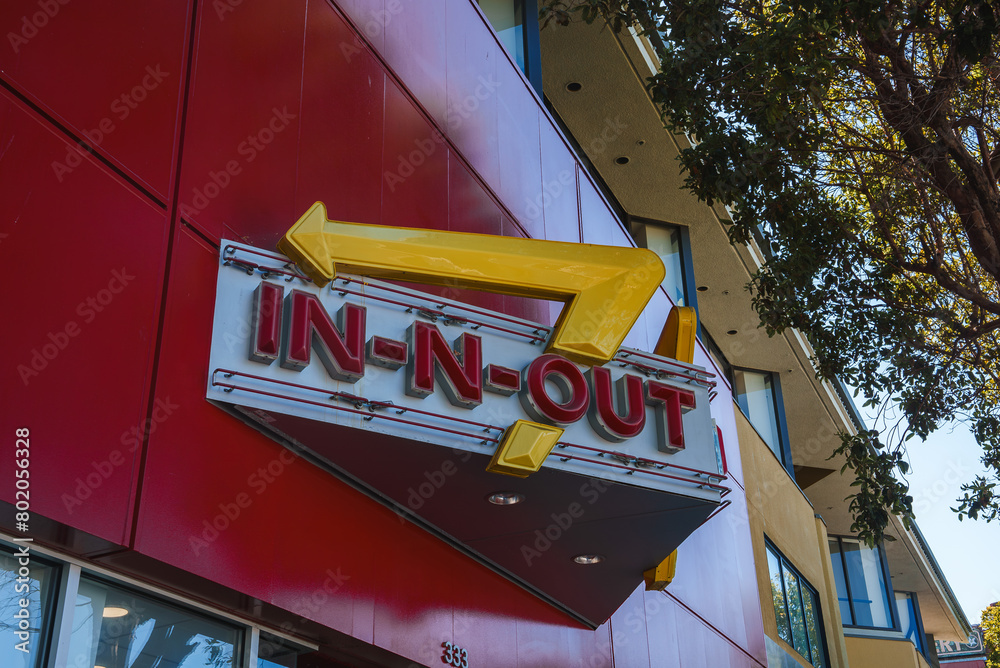 Iconic In N Out Burger sign in urban setting, San Francisco. Yellow ...