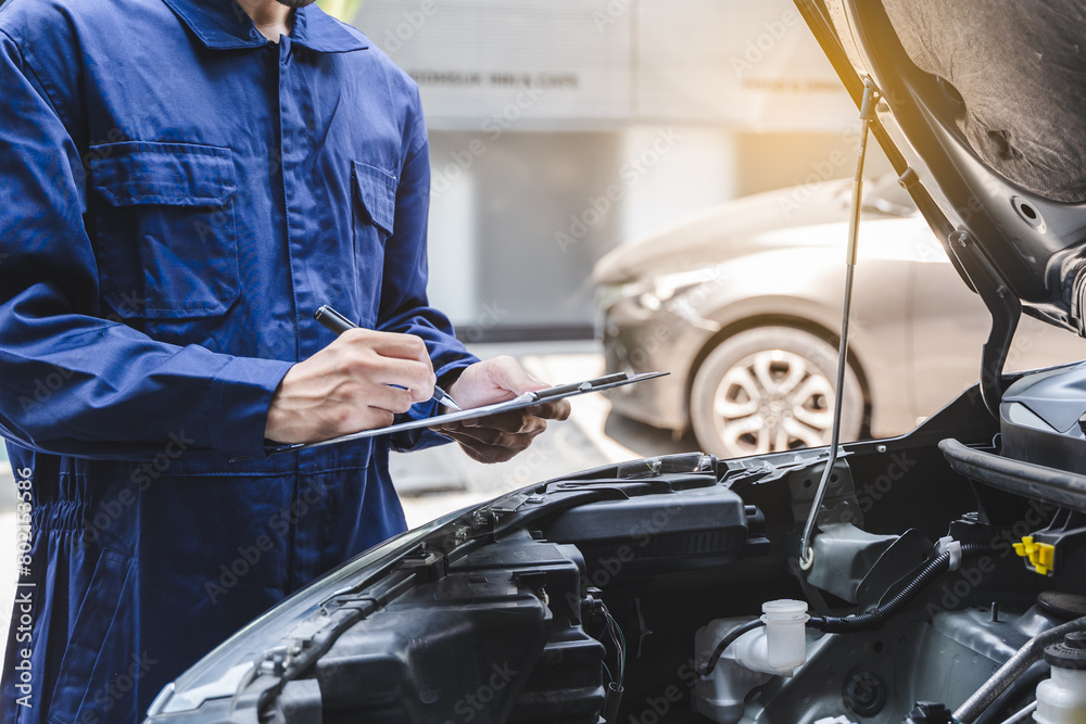 Auto check up and car service shop concept. Mechanic writing job ...