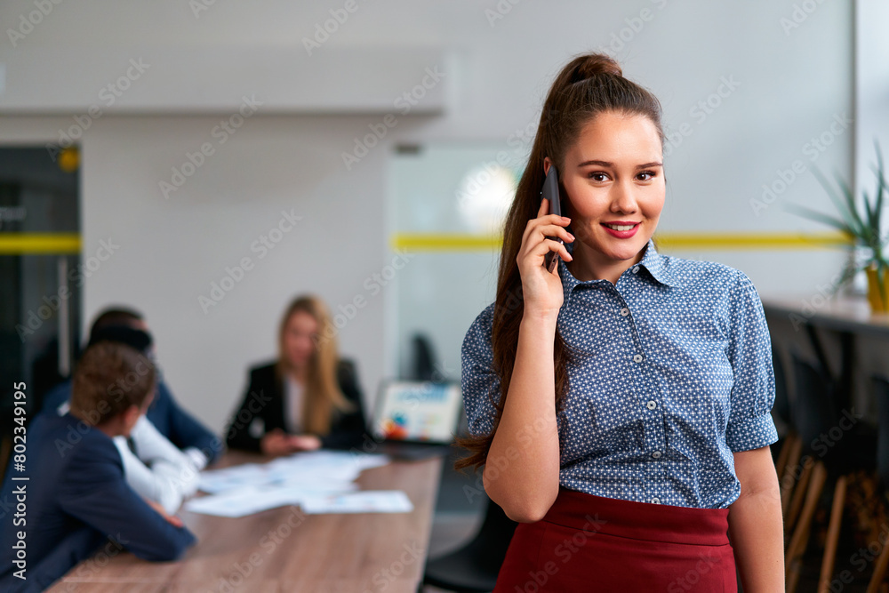 Asian businesswoman in smart casual attire talks on phone, confident ...