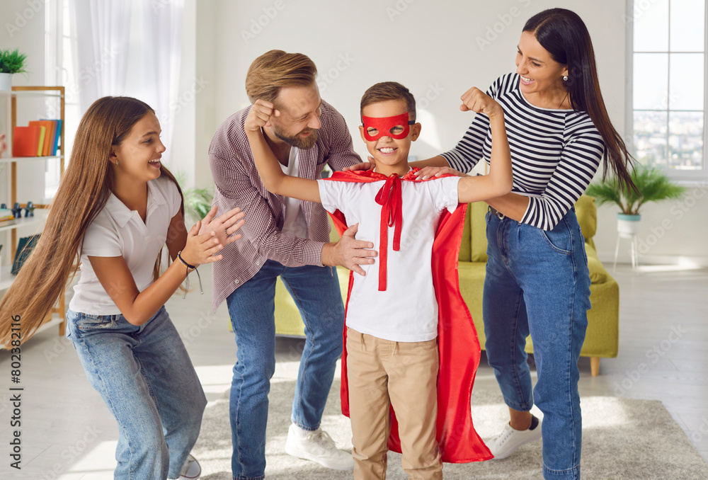 Little child is ready to protect people and save world. Cheerful kid in ...