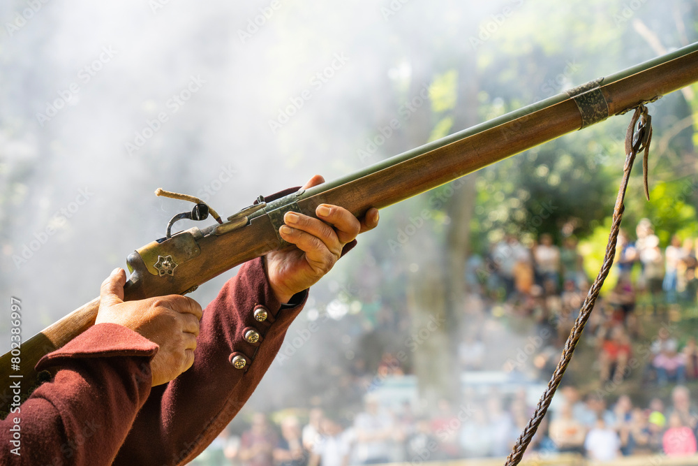 Firing a medieval musket at a demonstration Stock Photo | Adobe Stock