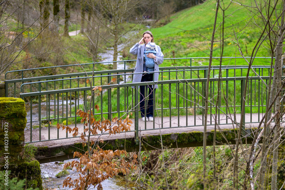 Stressed, exhausted and depressed woman standing on a bridge with her ...