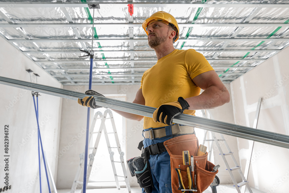 Plasterboard worker making a plasterboard ceiling. Assembling the ...
