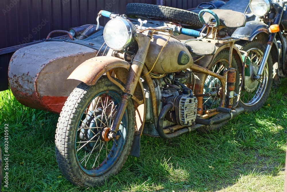 one retro beige iron old rusty broken dirty motorcycle with a sidecar ...