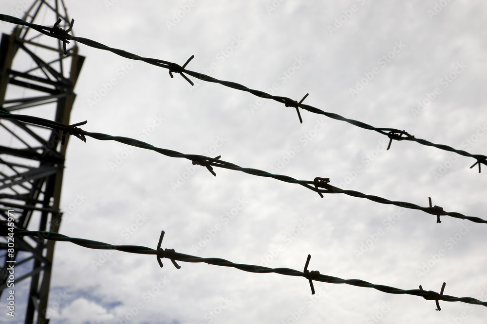 Three strands of barbed wire on the impassable border of the restricted ...