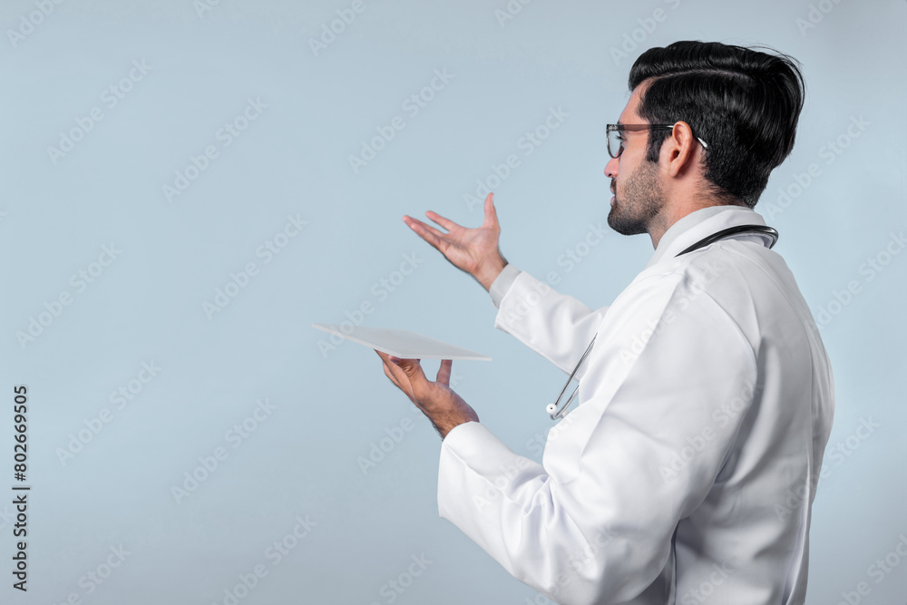 Back view of skilled doctor looking and pointing while holding ...