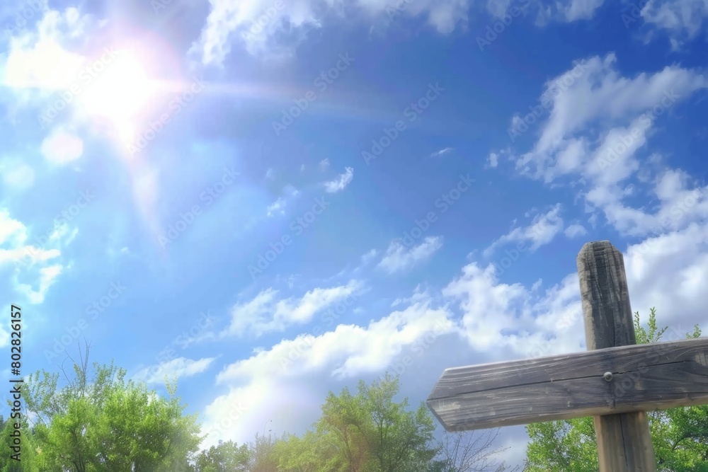 Wooden signpost under a radiant sun and blue sky, perfect for rustic ...