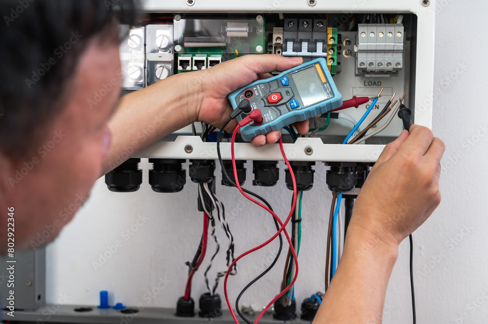 Expertise solar engineer with electric meter checking with hybrid solar ...