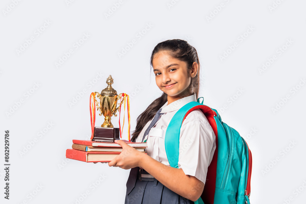 Excited Indian asian girl student in school uniform holding victory ...