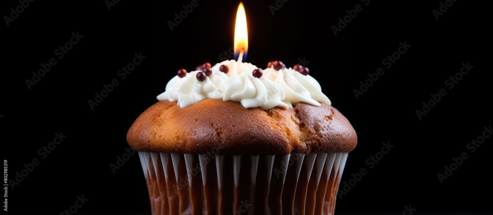 A black background with a muffin topped with a candle number 17 There ...