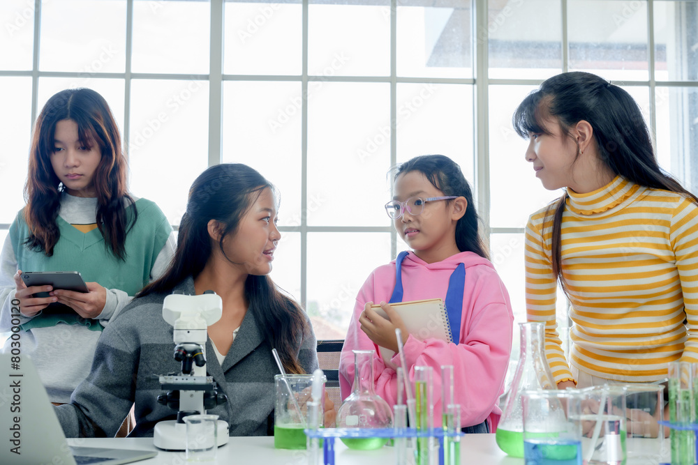 Students' learning in science classroom. Group of young students engage ...