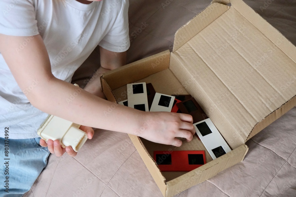 A child is watching slides through a slide show. Retro, slides. Old ...