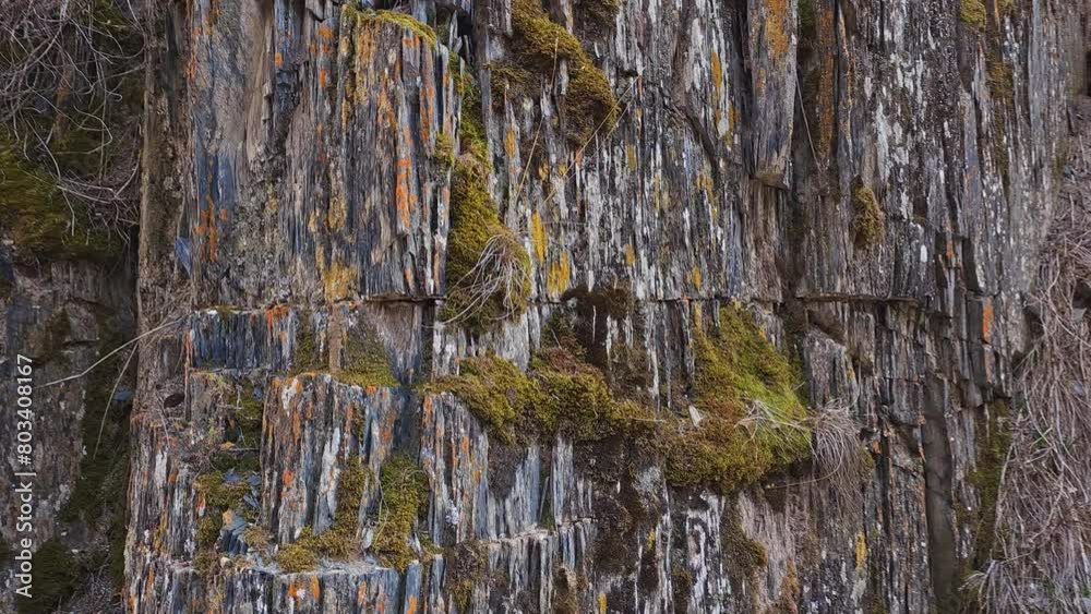 geological rock formation with vertical structure and moss covered ...