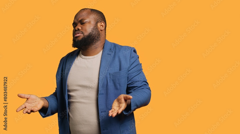 Uncaring man shrugs shoulders, showing indifference and apathy while ...