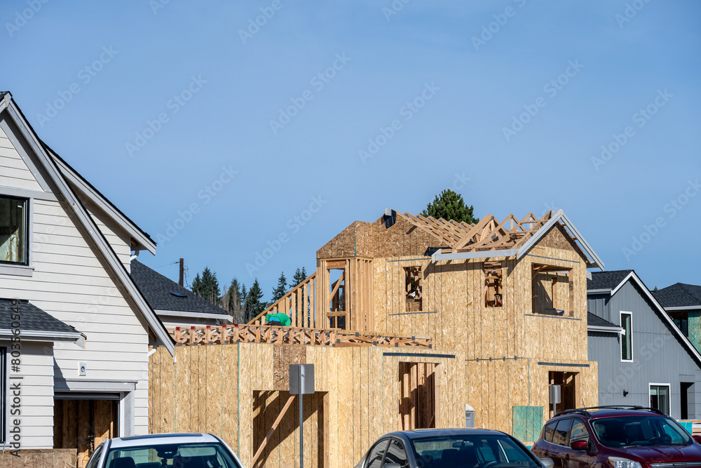 Various stages of new homes under construction in a cottage community ...