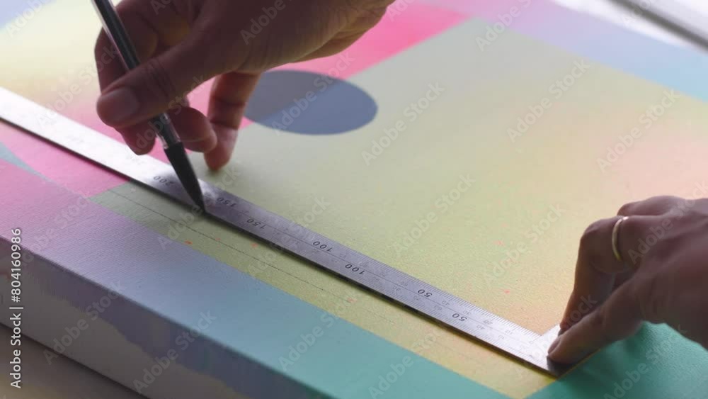 A diverse biracial female artist, draws straight lines with a pencil ...