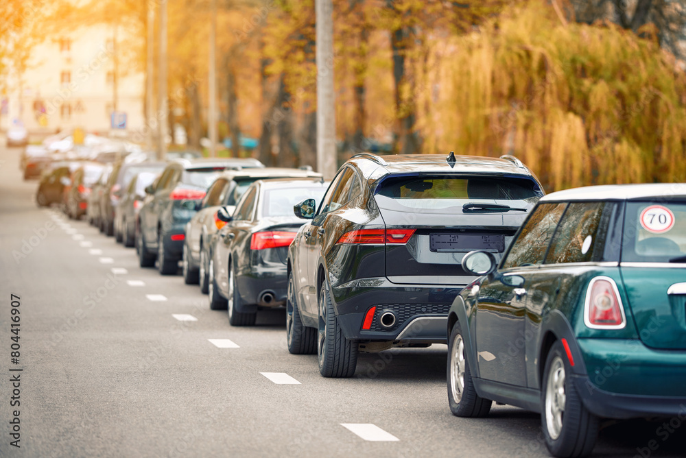 Cars parked at roadside in residential area, parking zone. Parking ...