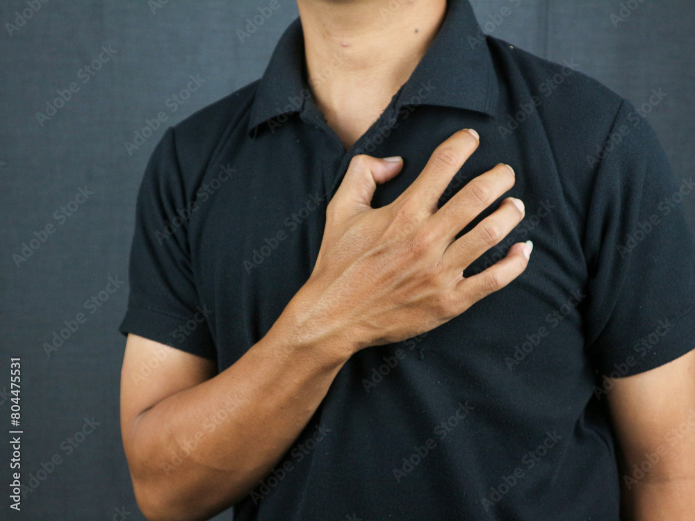 Man clutching his chest from acute pain. Heart attack symptom pressing ...