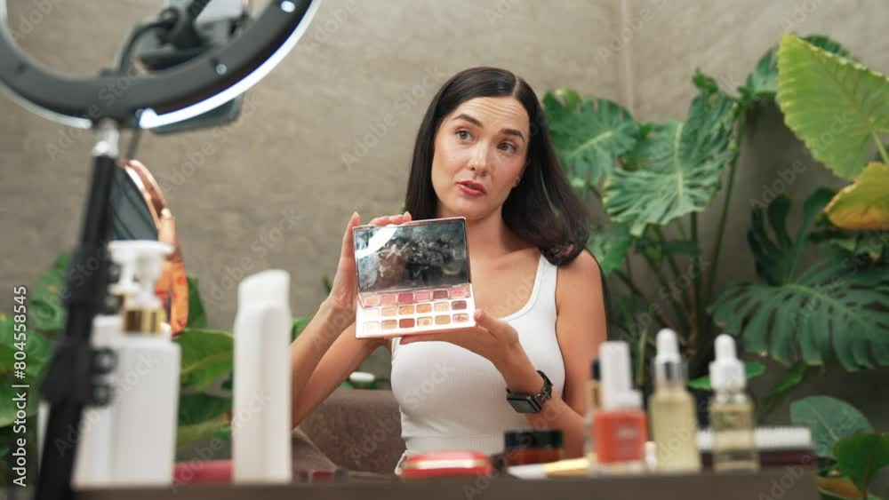 Beautiful content creator making natural beauty and cosmetic tutorial at green plant leave ...