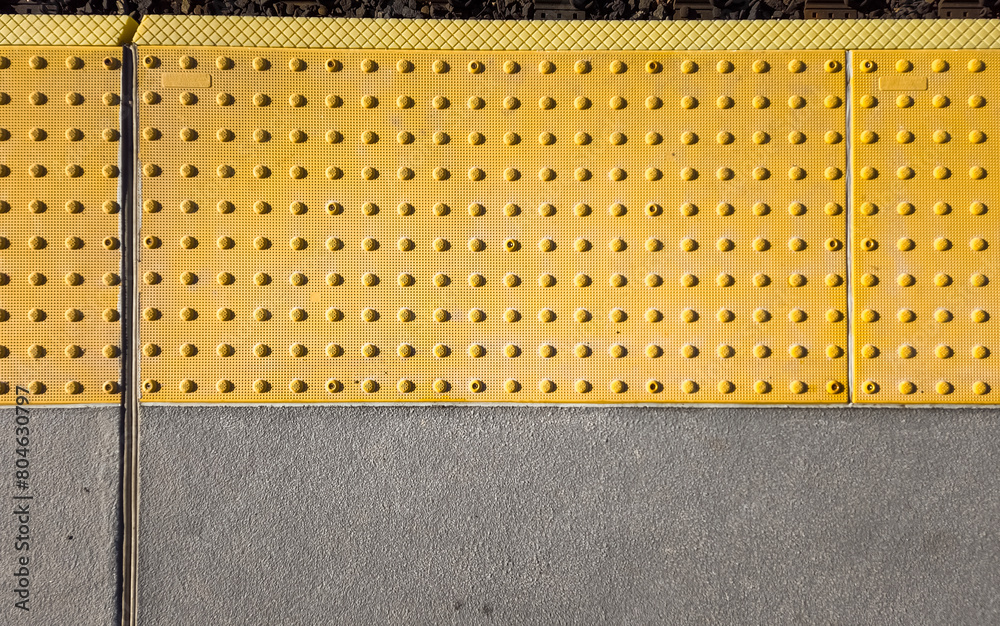 Yellow warning tile bumps in front of train tracks Stock Photo | Adobe ...