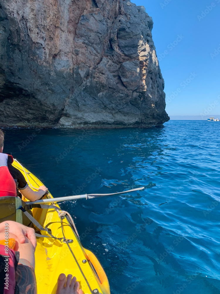two happy children in kayak back view, tourists kayaking on sea on ...
