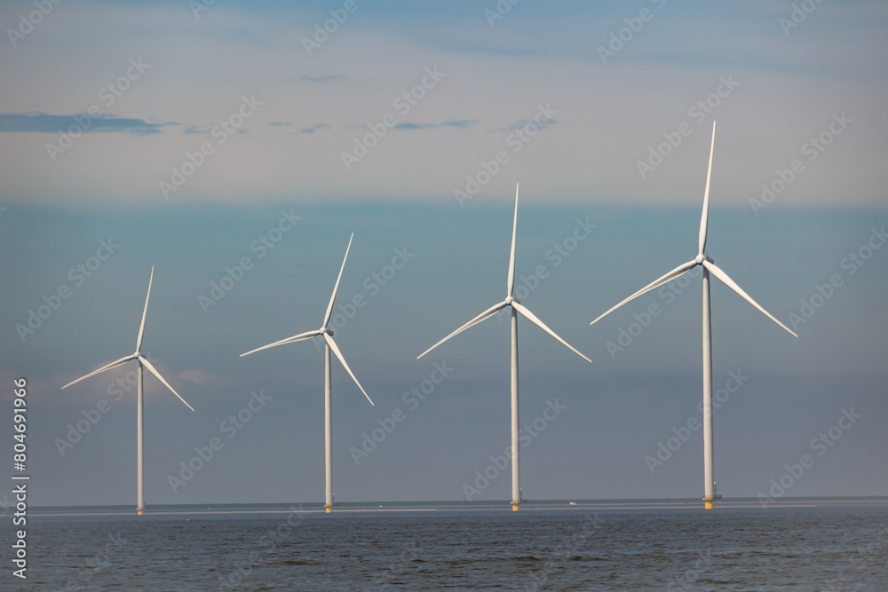 Wind farm of wind mills, generators, wind turbines, off shore in a sea ...