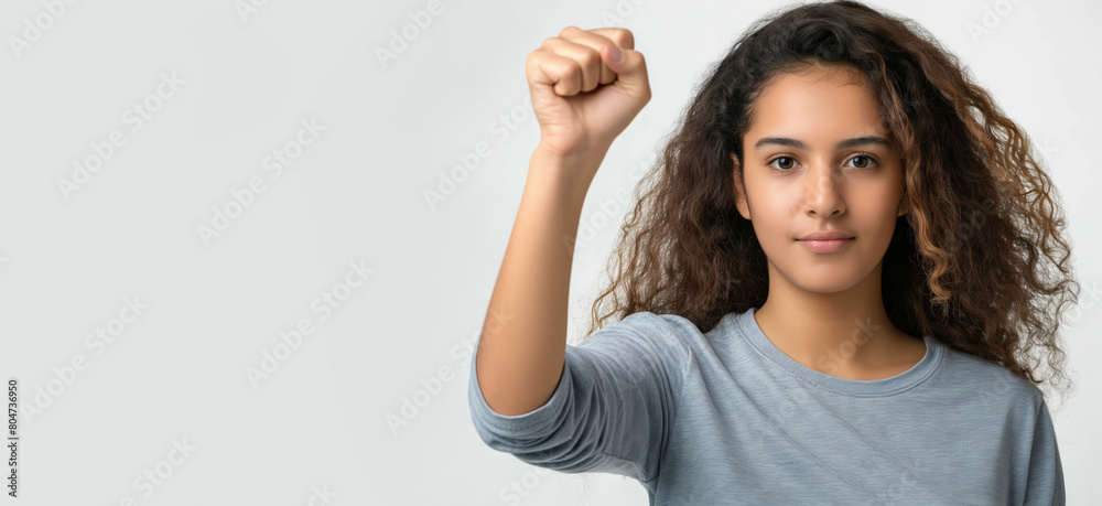 Empowered Young Woman With Raised Fist Symbolizing Unity, Strength, and ...