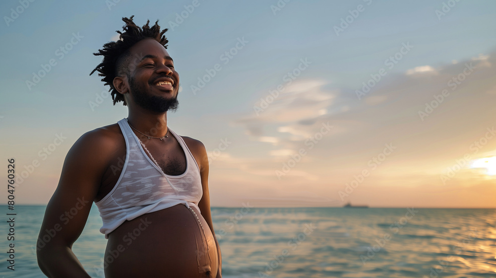 Pregnant transgender man cradling baby bump. Happy african american ...