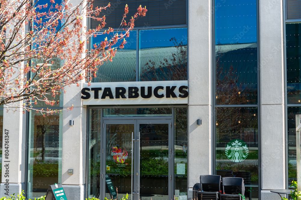 exterior building and sign of Starbucks, a coffee house chain, located ...