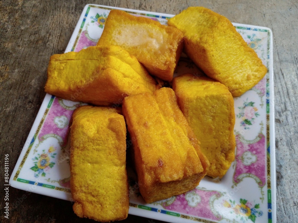 Tahu kediri. Yellow tofu or what is known as tofu kediri which has been ...