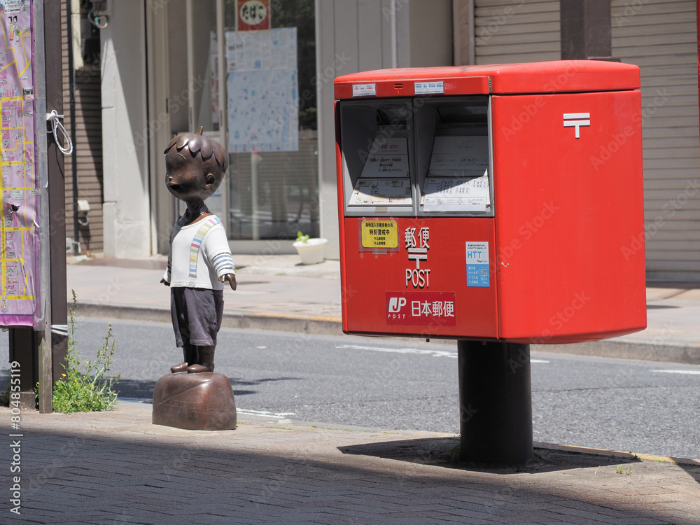 TOKYO, JAPAN - May 3, 2024: A post box and a statue of Kobo-Chan, a ...