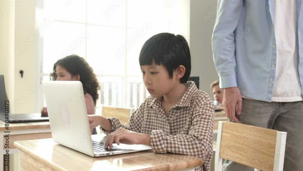 Caucasian teacher helping asian student coding engineering prompt while diverse student using ...