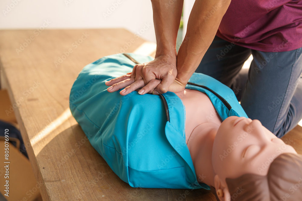 Close-up of middle-aged Asian male hands performing cardiopulmonary ...