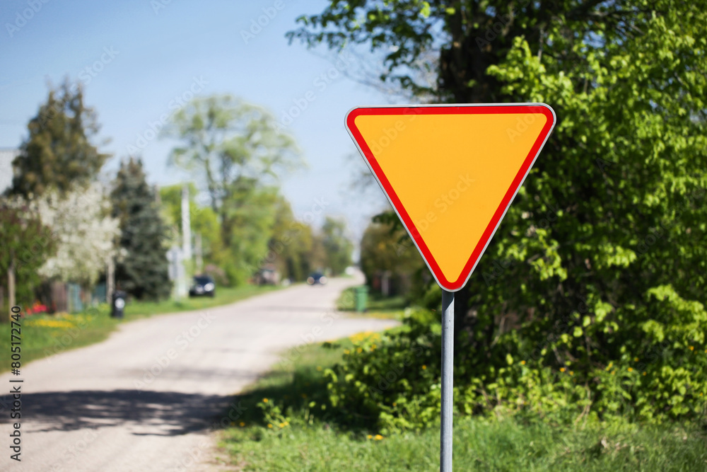 Give way traffic sign. Sign on the side of the road. Yellow triangle ...