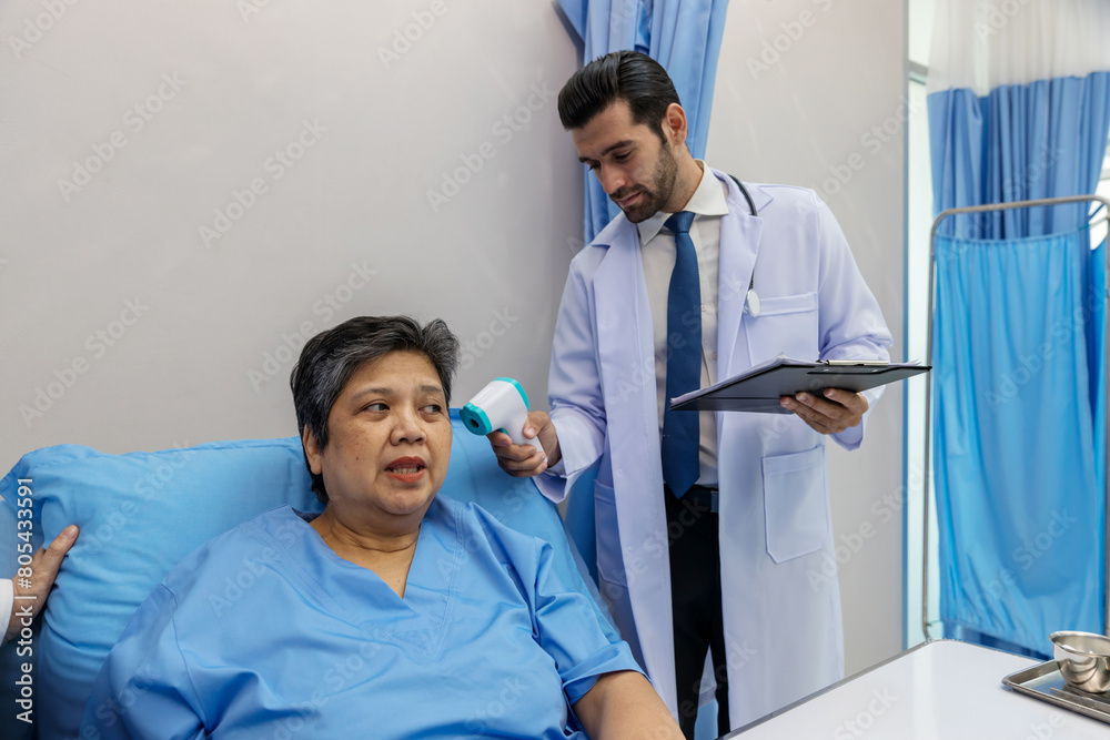 Doctor Visiting Patient On Ward. Hospitalized man lying in bed while ...