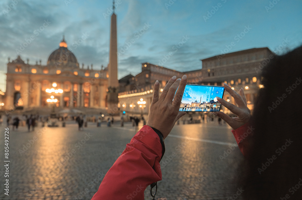 A person stands in awe, raising their cell phone to capture the ...