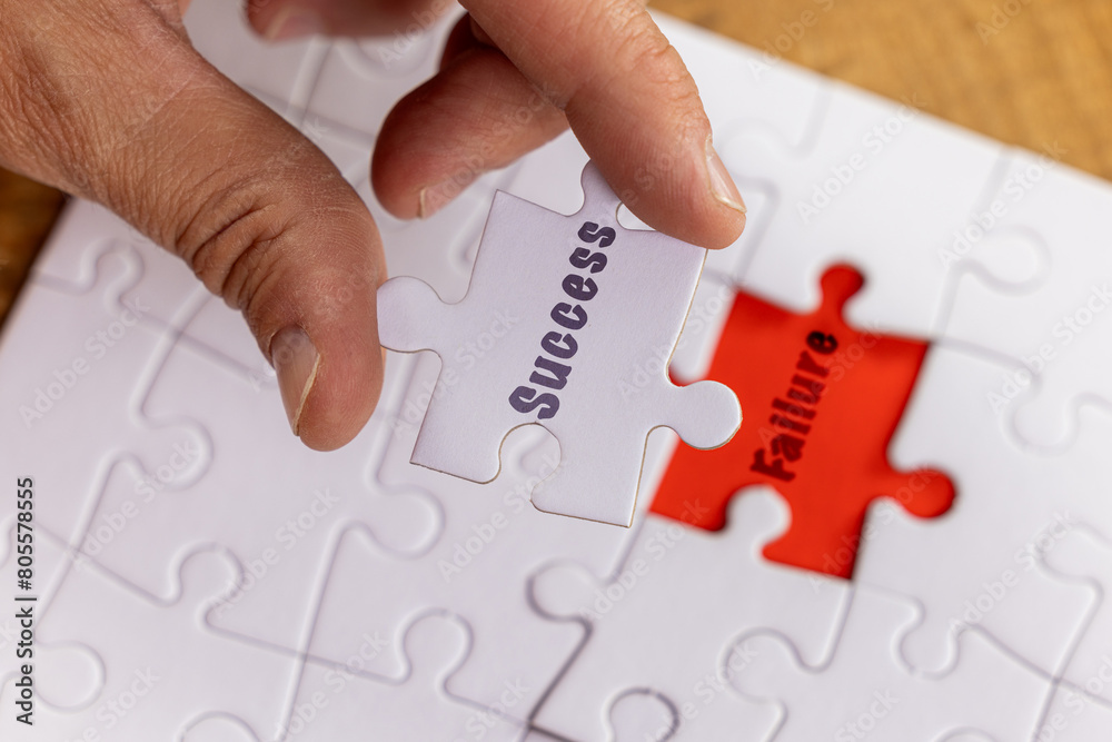 Blank puzzle with the word success over the missing piece being held ...